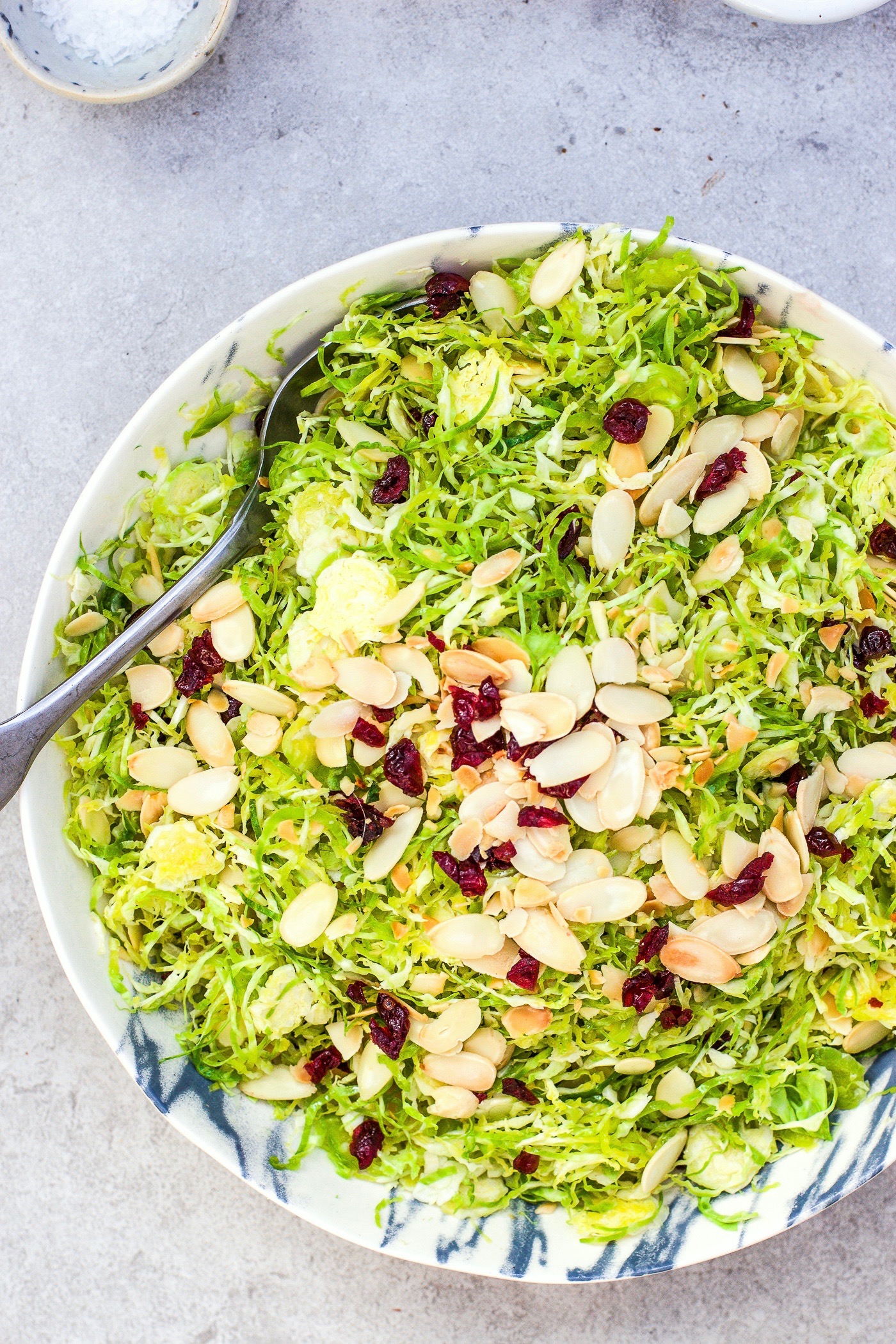 Brussel Sprout Slaw with Cranberries & Almonds - The Little Green Spoon